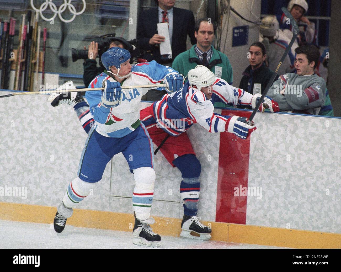 Italy’s Roland Ramoser, left, uses his stick to check USA’s Peter ...