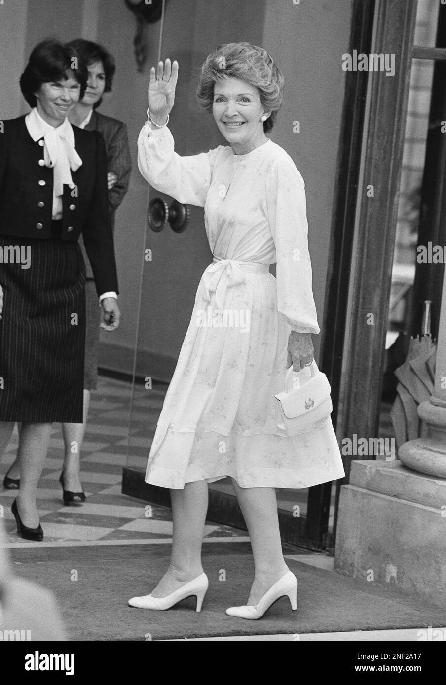 Mrs. Nancy Reagan waves as she arrives for lunch with Mrs. Danielle ...
