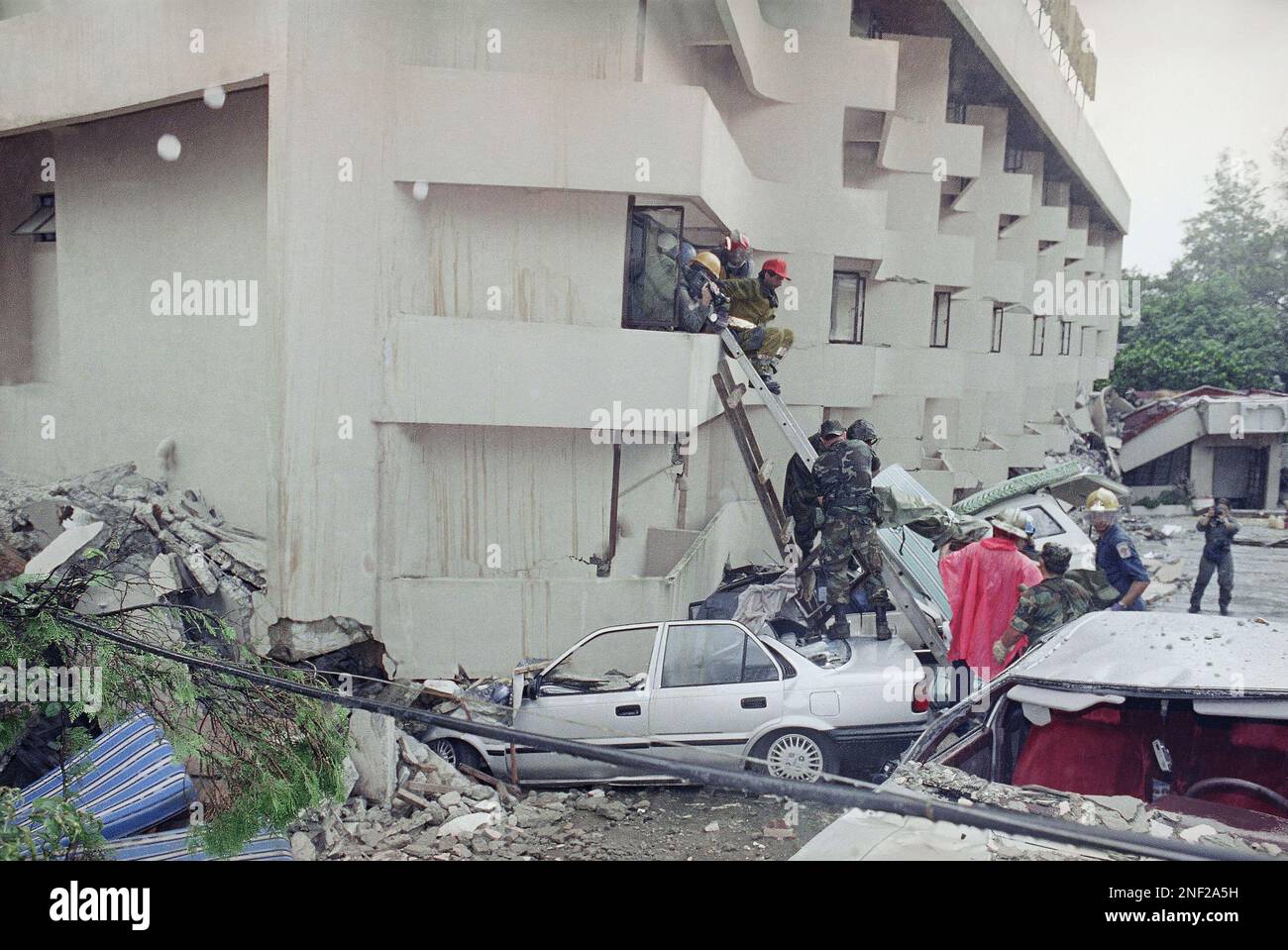 Filipino and U.S. rescue workers lower the body of Richard Finley, a ...