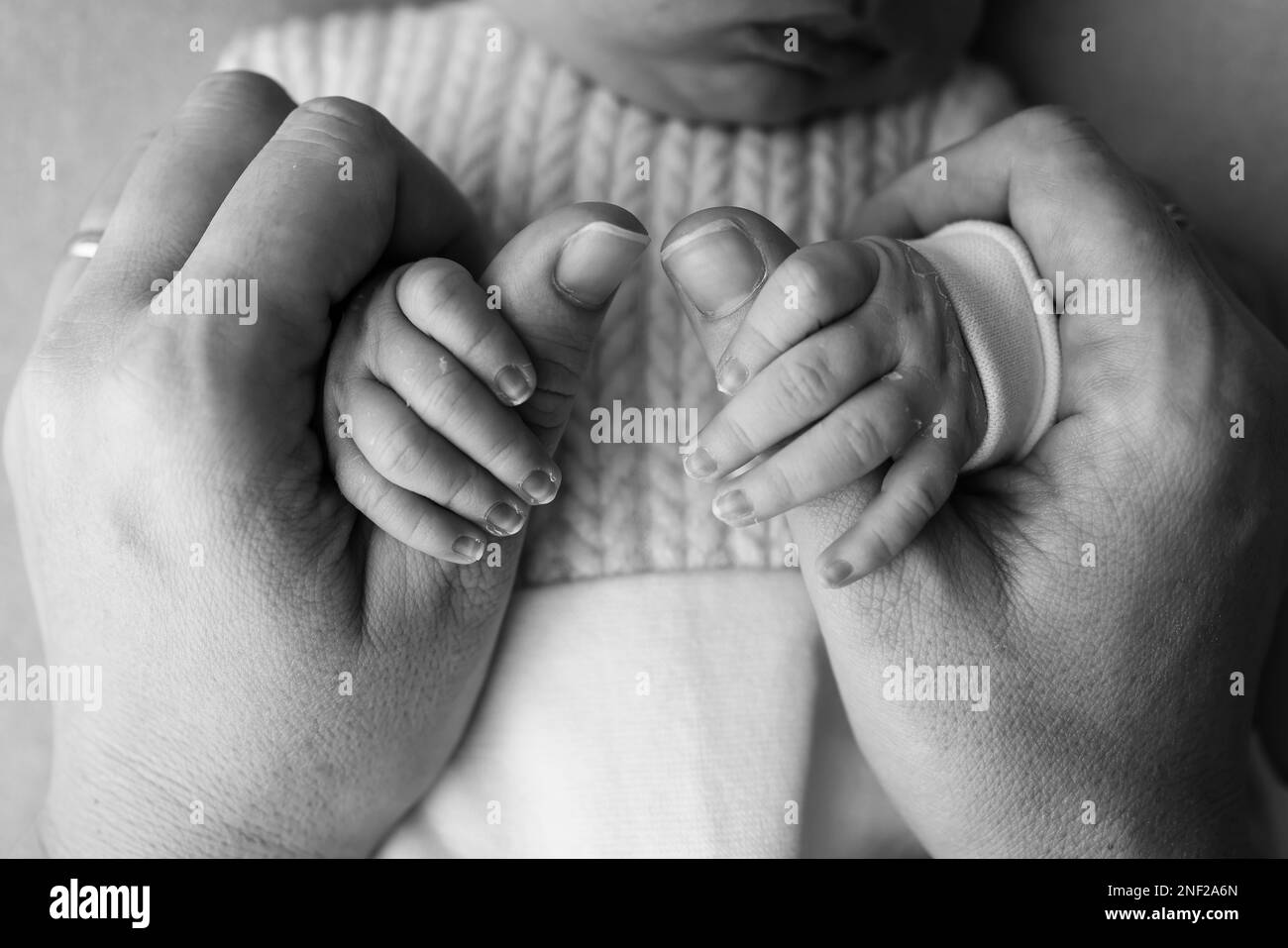 The newborn baby has a firm grip on the parent's finger after birth ...