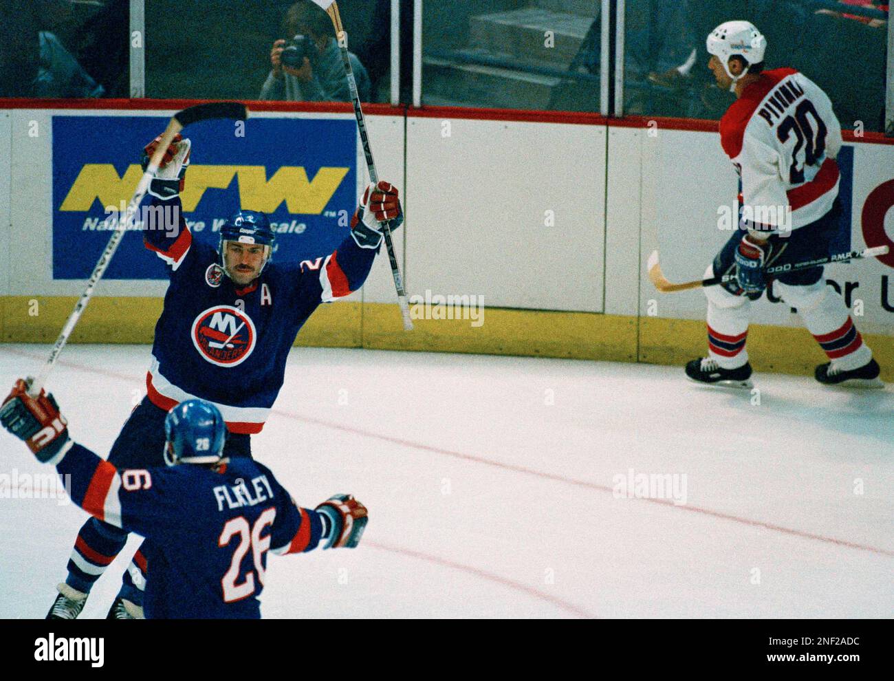 New York Islanders Uwe Krupp, top, celebrates his goal, the first of ...