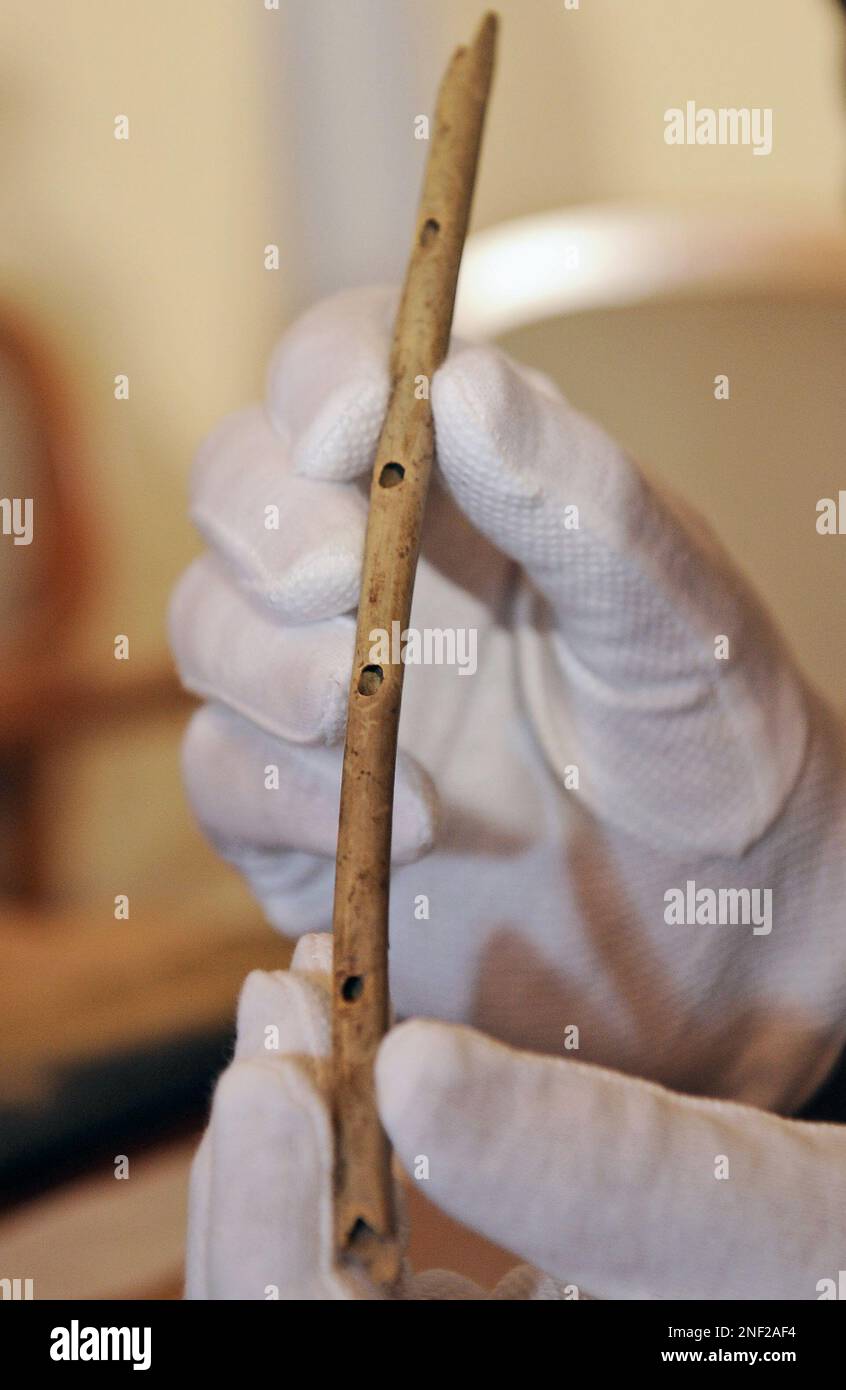 Professor Nicholas Conard of the University in Tuebingen shows a flute ...