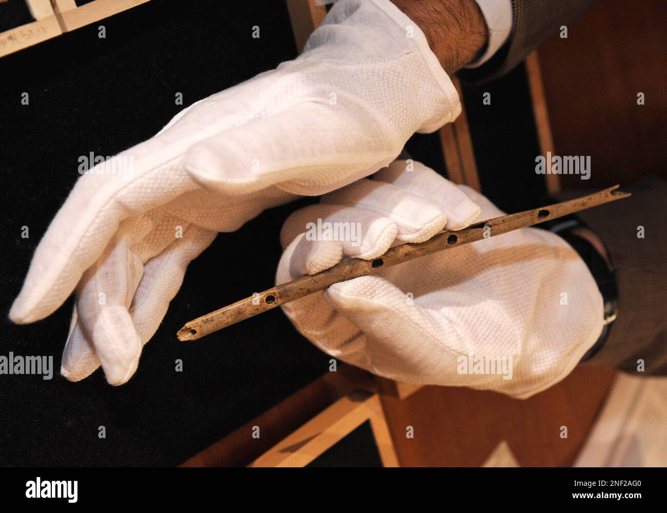 Professor Nicholas Conard of the University in Tuebingen shows a flute ...