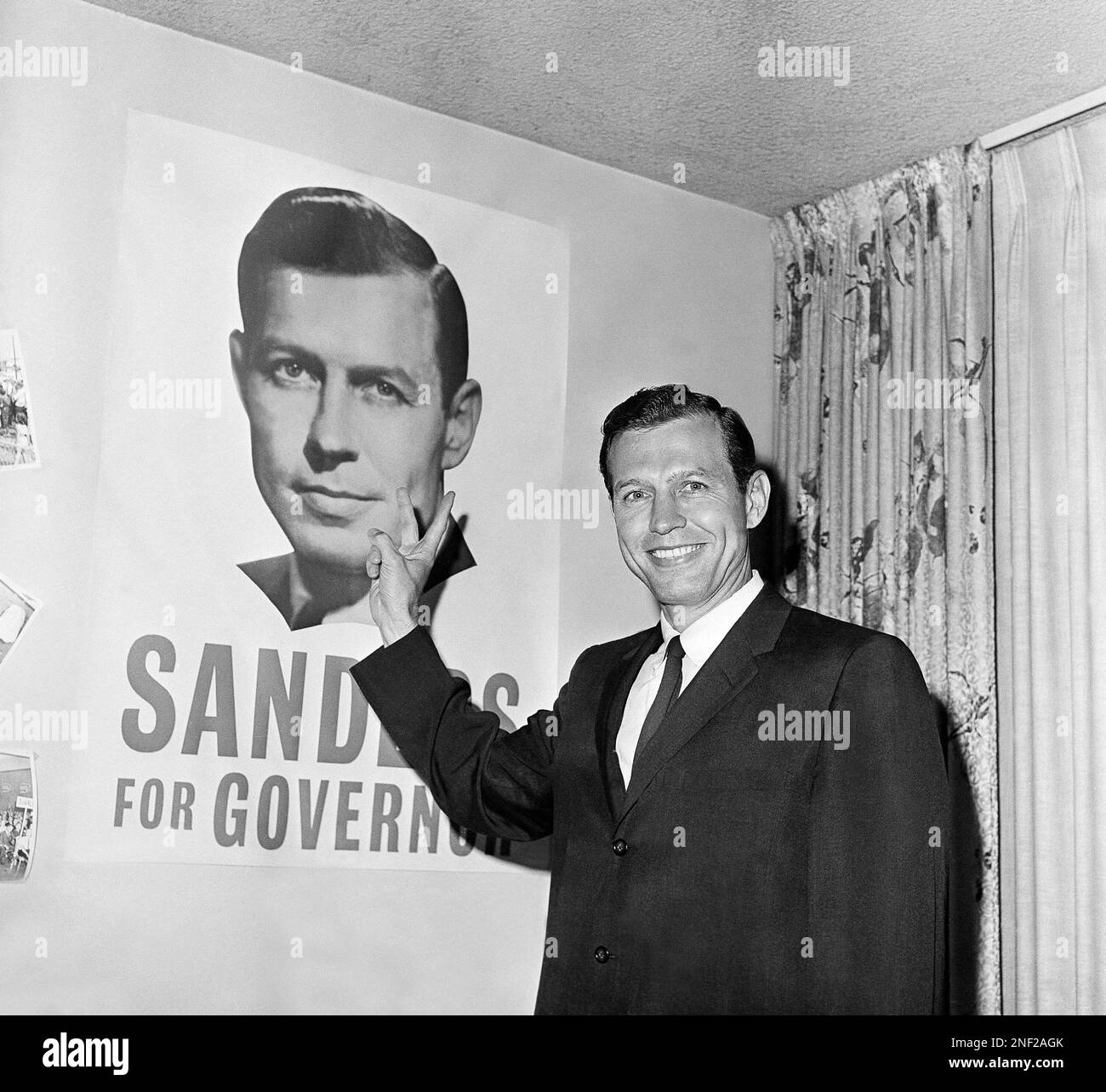 Carl E. Sanders gives a victory sign at his headquarters in Atlanta on ...