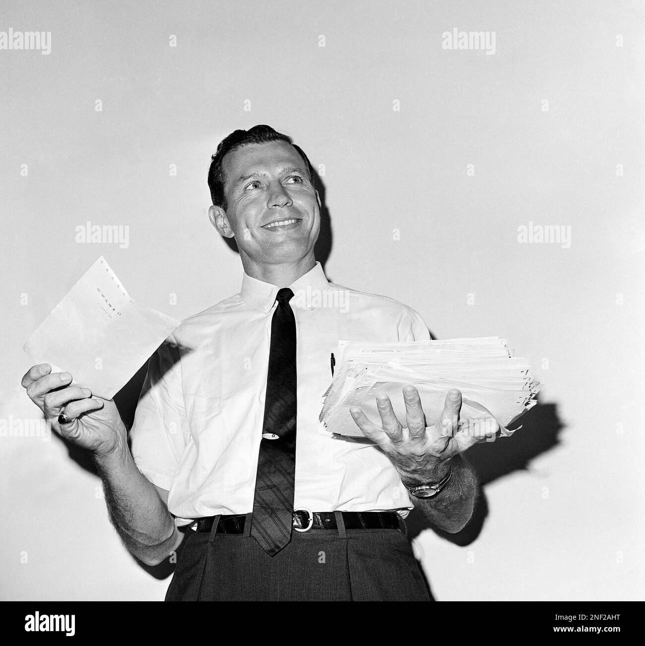 Carl Sanders reads a stack of telegrams from friends congratulating him ...