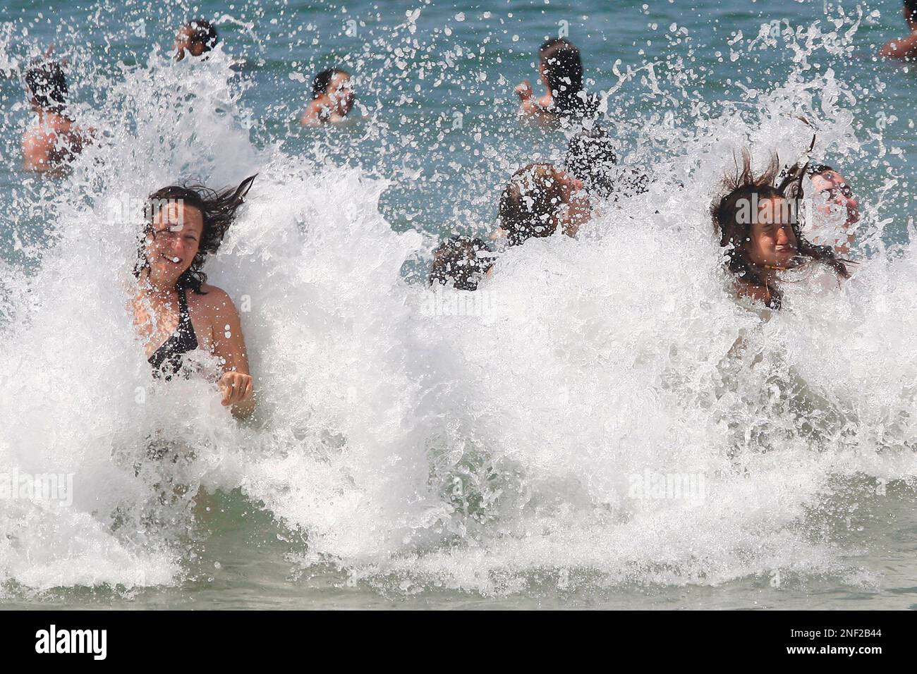 People enjoy a swim in the Atlantic ocean on Biarritz beach ...