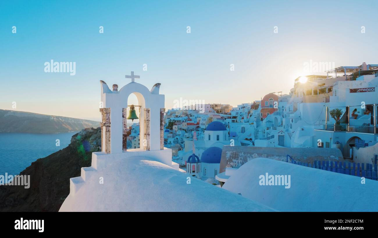 sunset by the ocean of Oia Santorini Greece, a traditional Greek ...