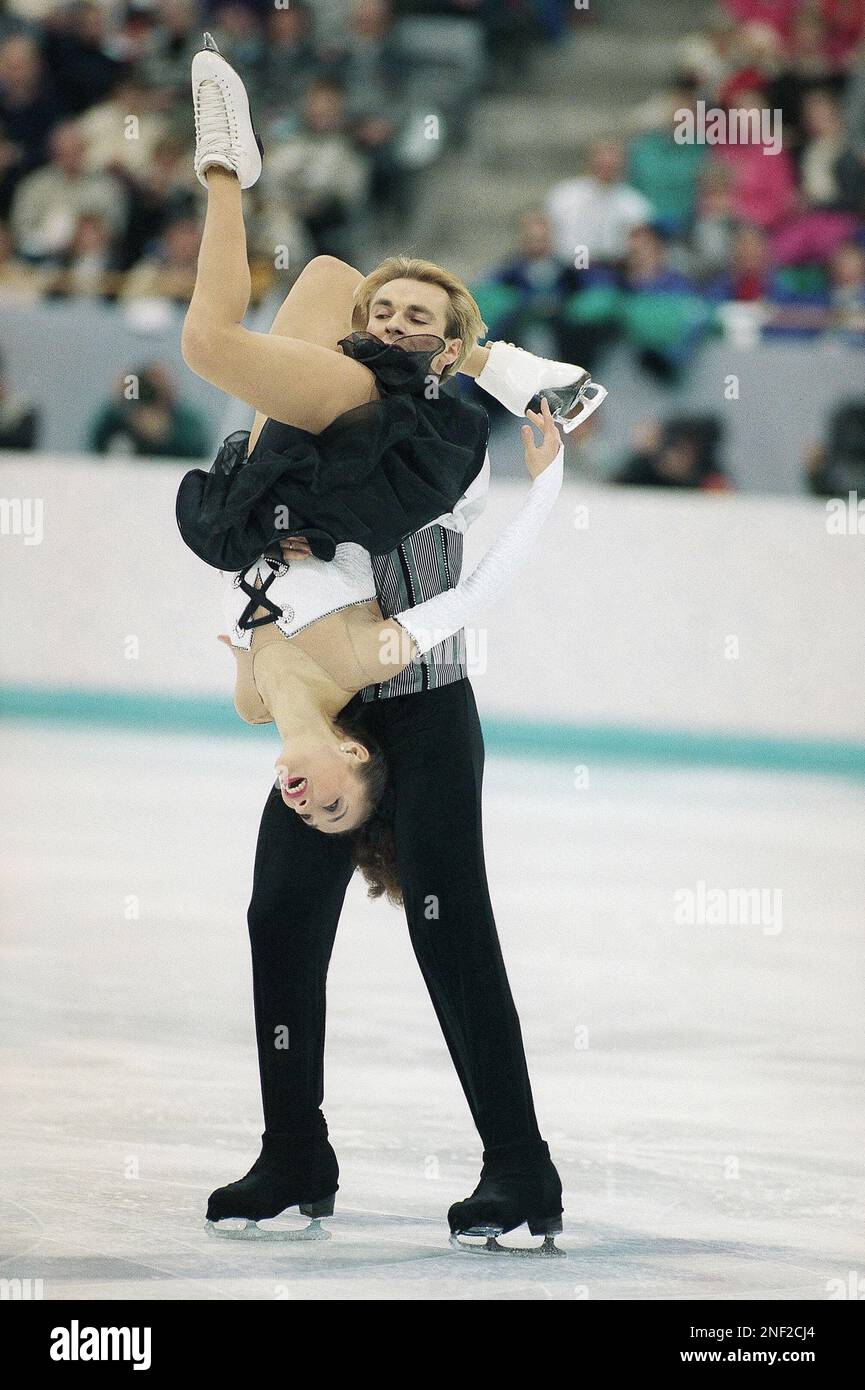 Russian figure skater Alexander Zhulin holds onto Maya Usova during ...