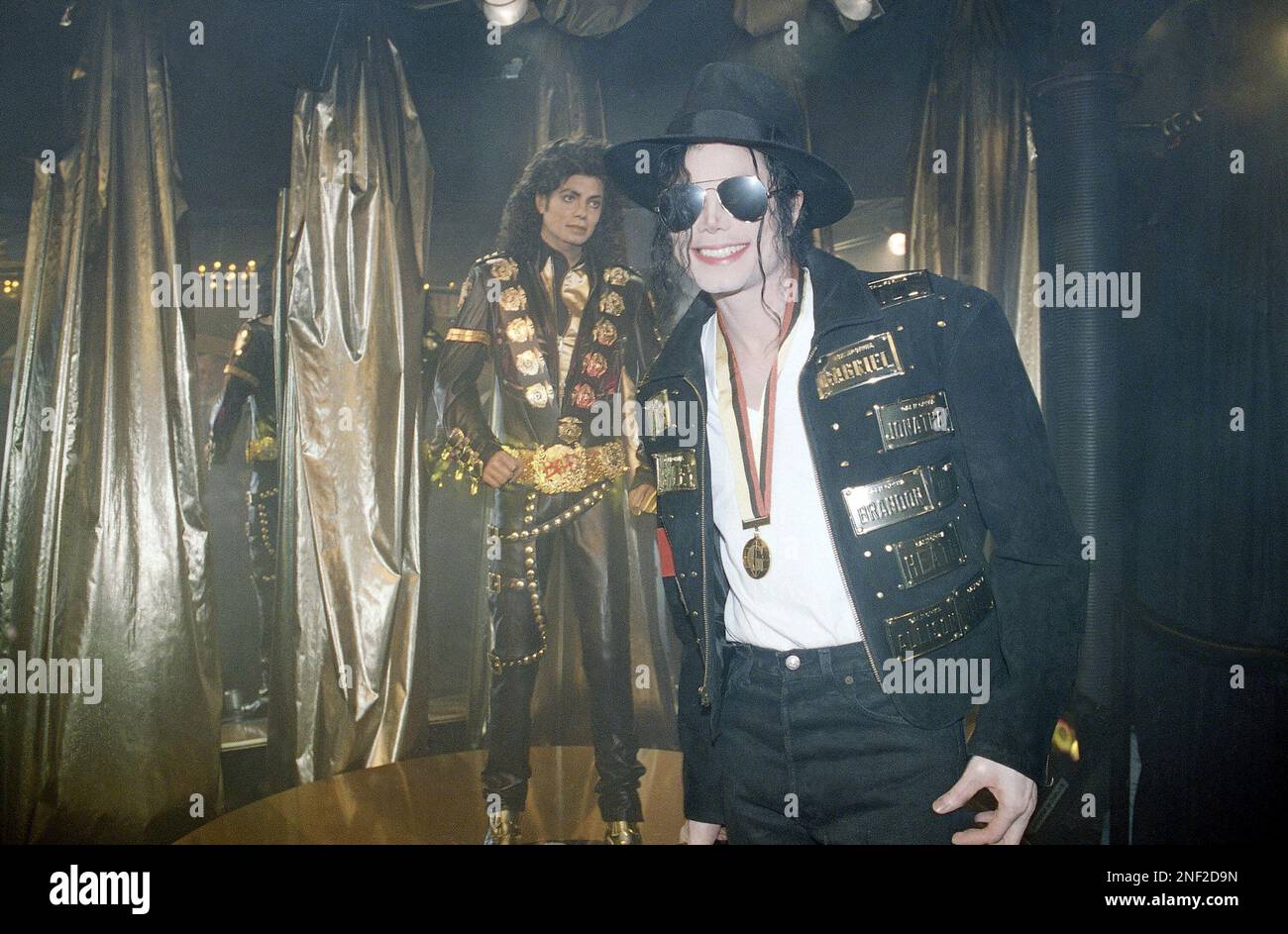 Pop star Michael Jackson poses in front of a life-sized wax figure of ...
