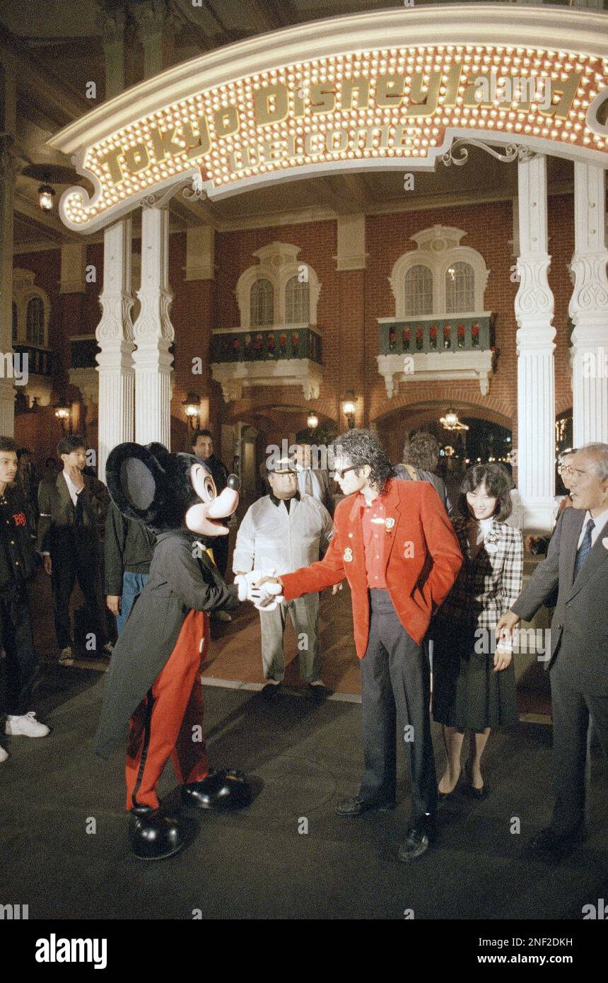 Michael Jackson shakes hands with Mickey Mouse as the American ...