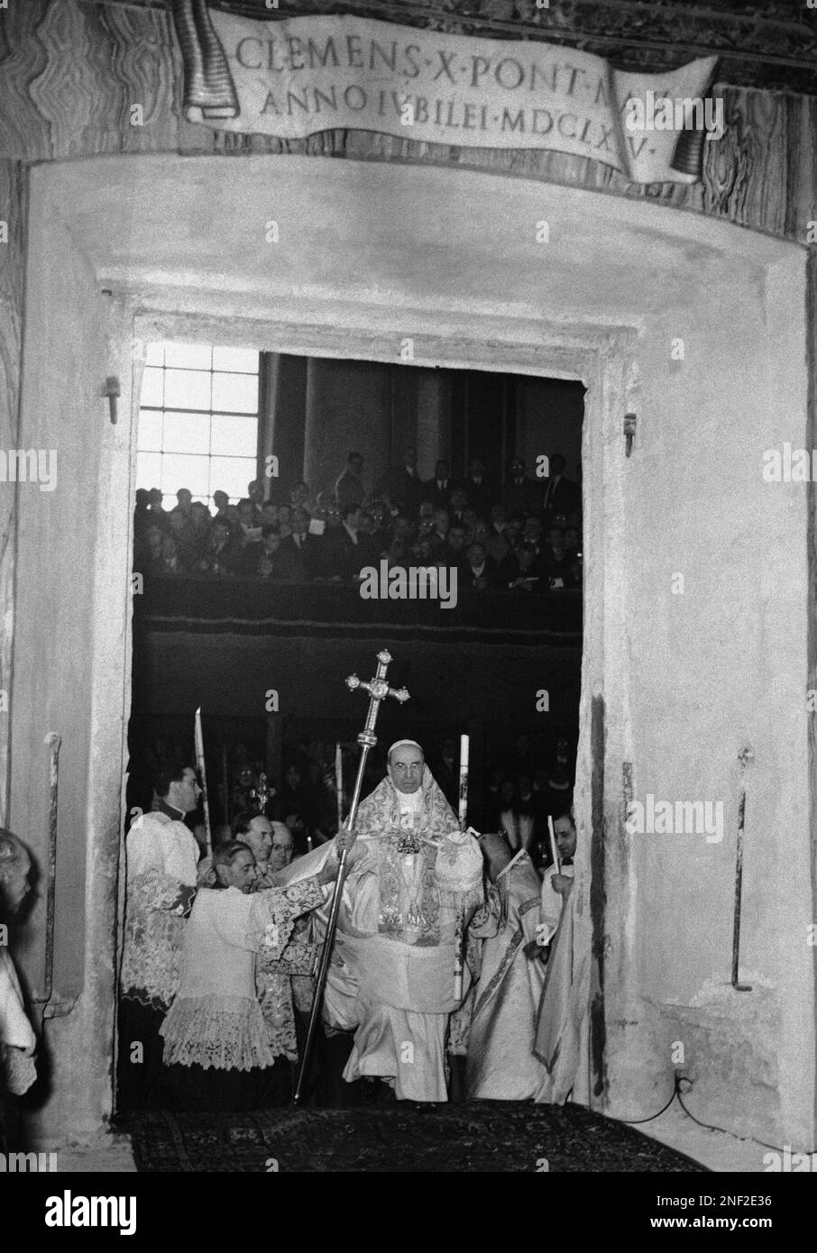 Carrying a candle and a cross, Pope Pius XII crosses the threshold of ...