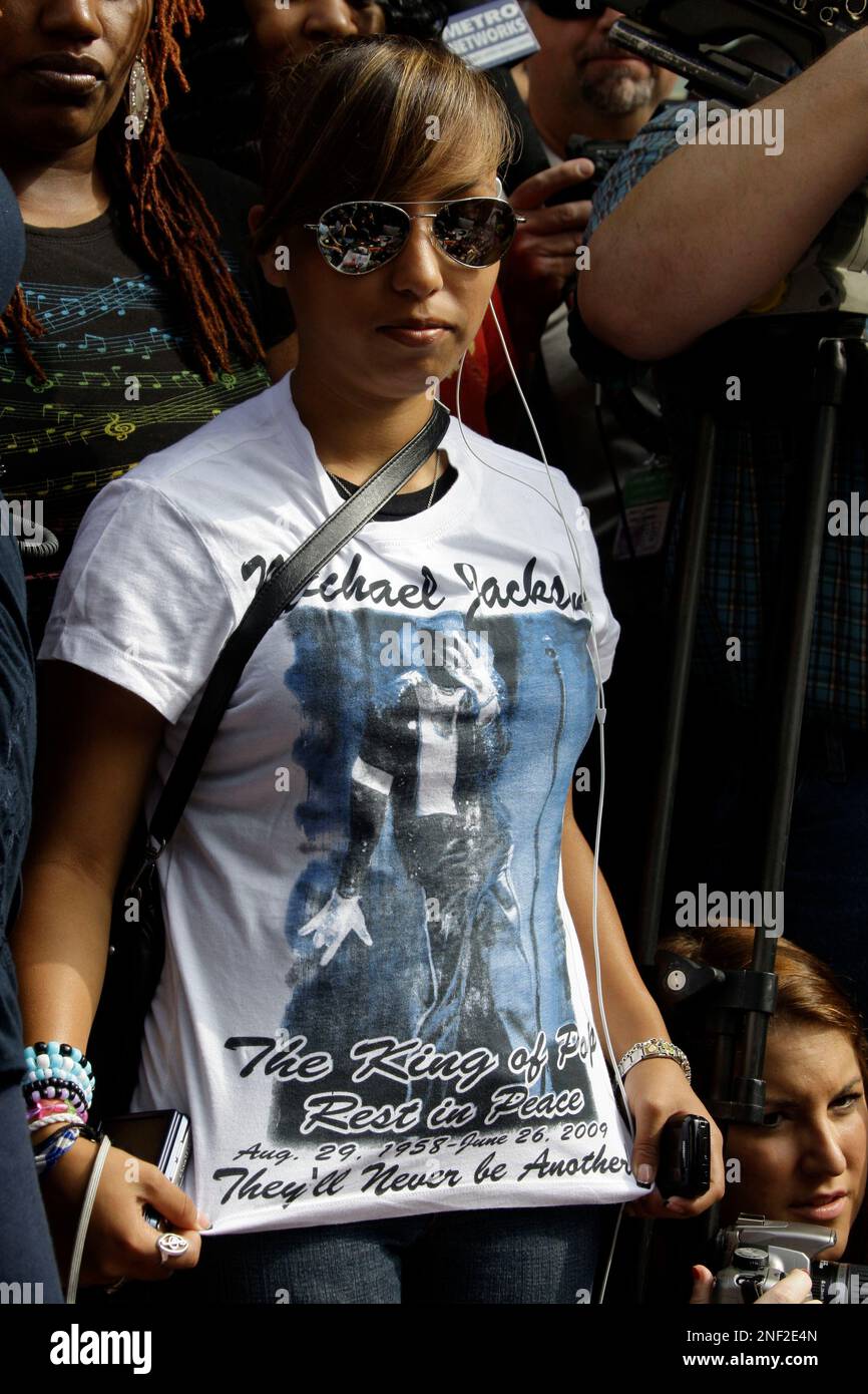 Alma Gomez, 17, of Los Angeles, stands at a sidewalk shrine of ...