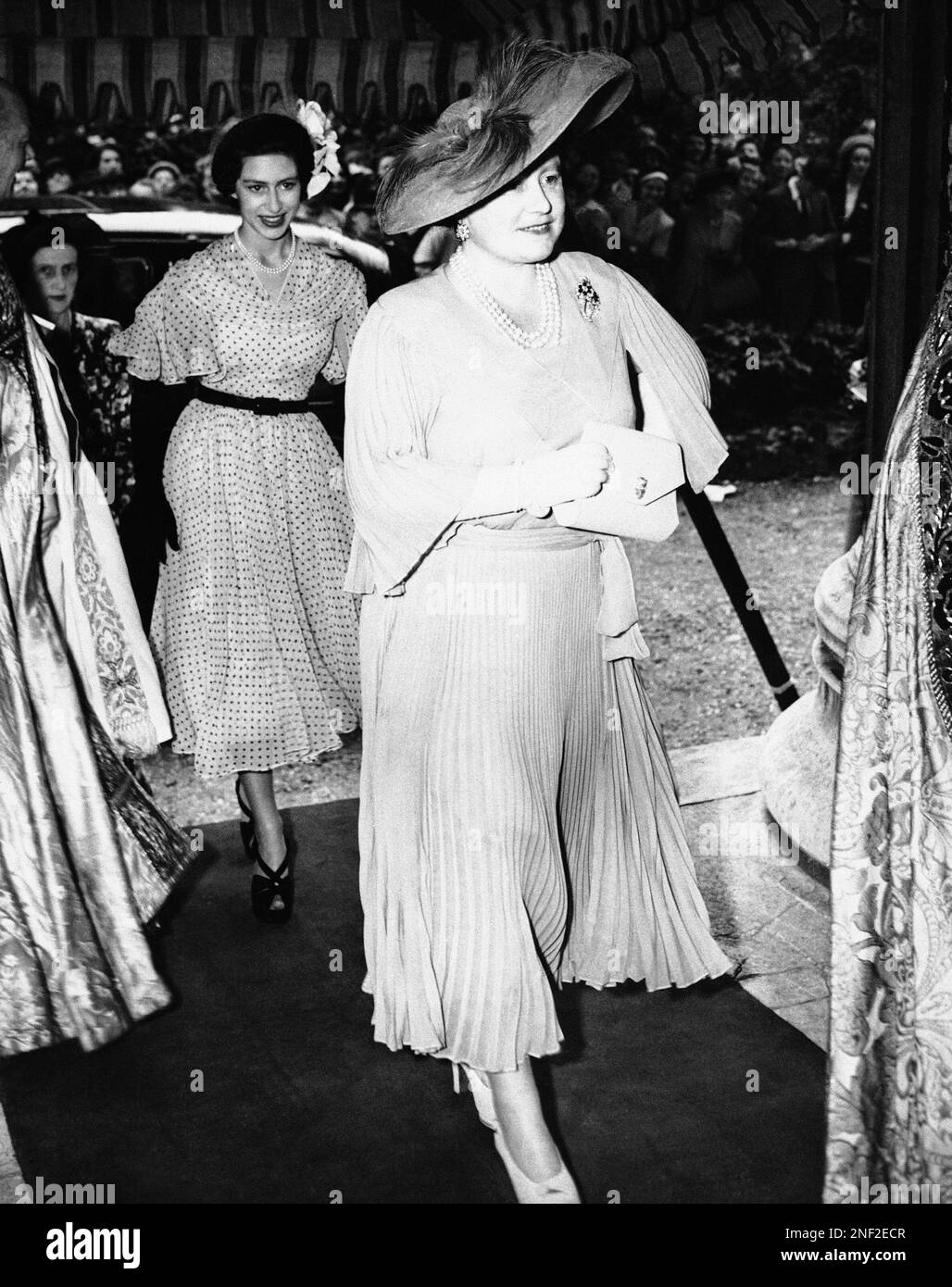 Queen Elizabeth (front) and Princess Margaret Rose (following the Queen ...
