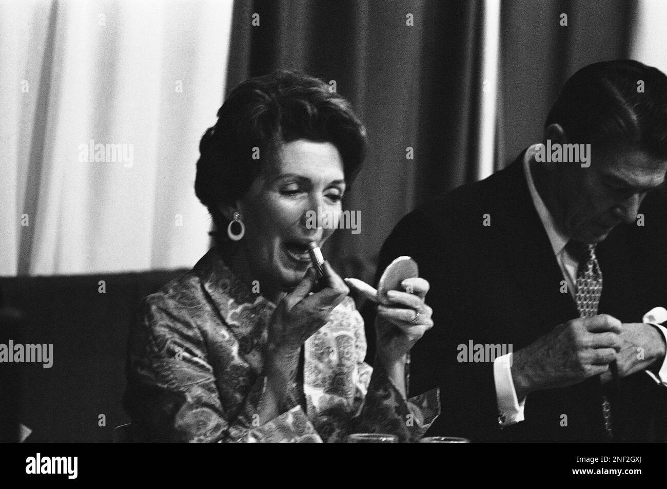 Nancy Reagan freshens her makeup during an appearance with her husband ...