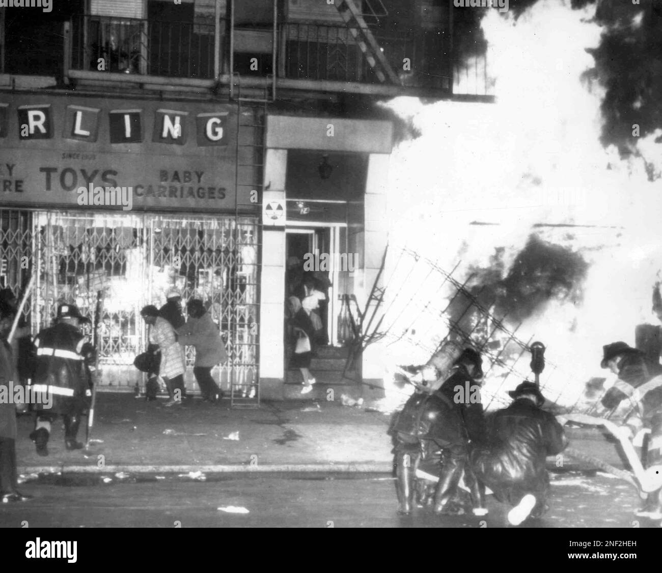 Firemen battle a blaze on 125th Street in Harlem, New York, on April 4 ...
