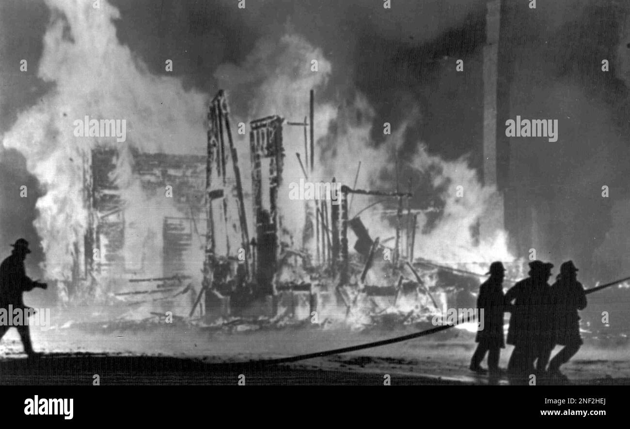 Firemen fight to control blazing buildings after racial riots in ...