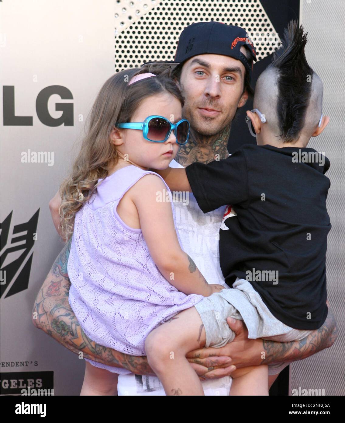 Travis Barker, center, with his daughter, left, and son arrive at the ...
