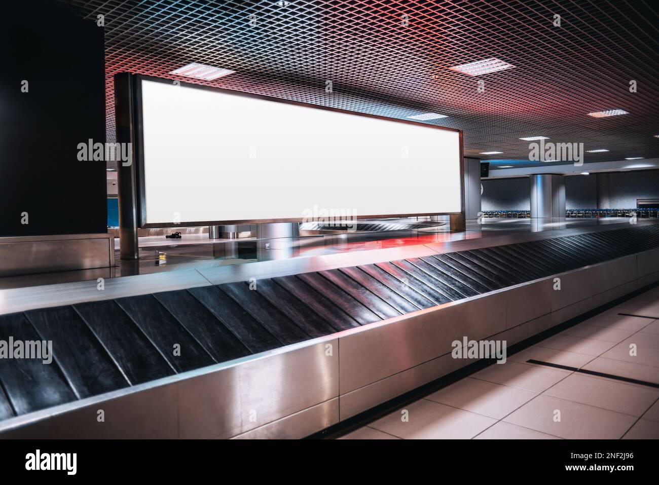 Shot in low-key of a very large rectangular blank billboard mockup ...