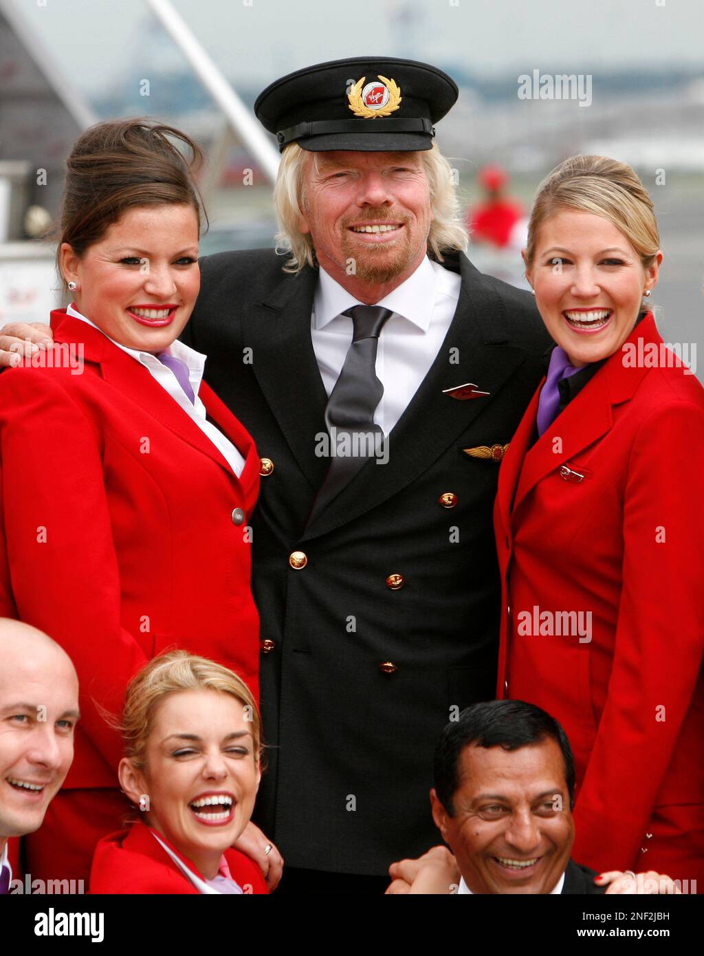 Sir Richard Branson, center, celebrates with crew members after ...