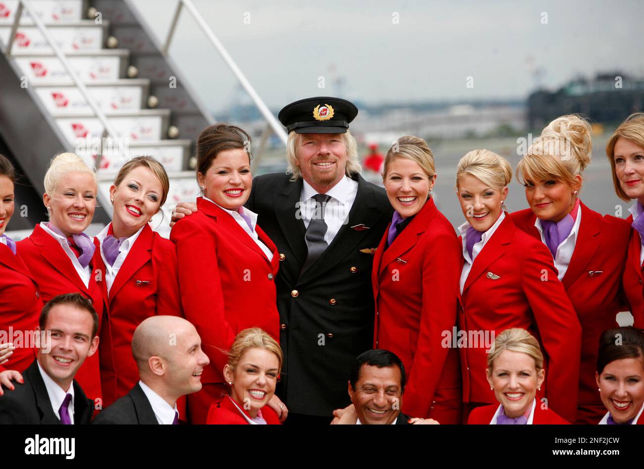Sir Richard Branson, center, celebrates with crew members after ...