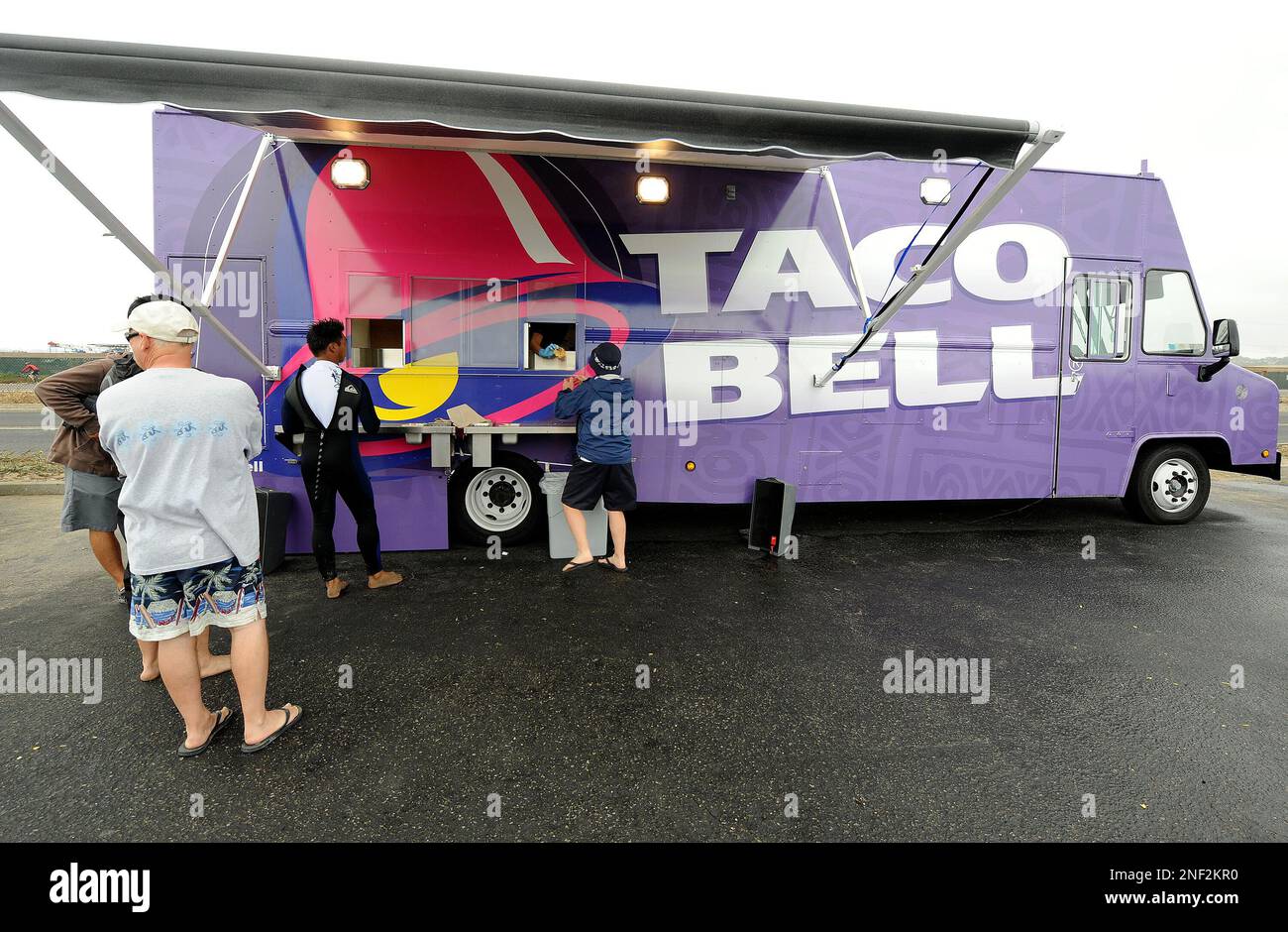 Beach clean up volunteers and surfers are given a complimentary Taco ...