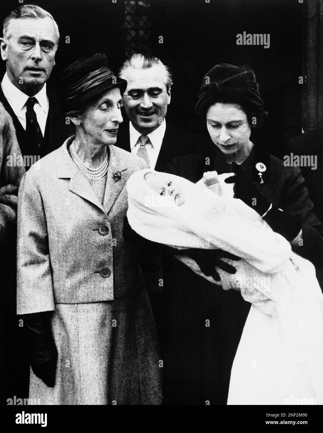 Britain's Queen Elizabeth II holds the infant daughter of David and ...