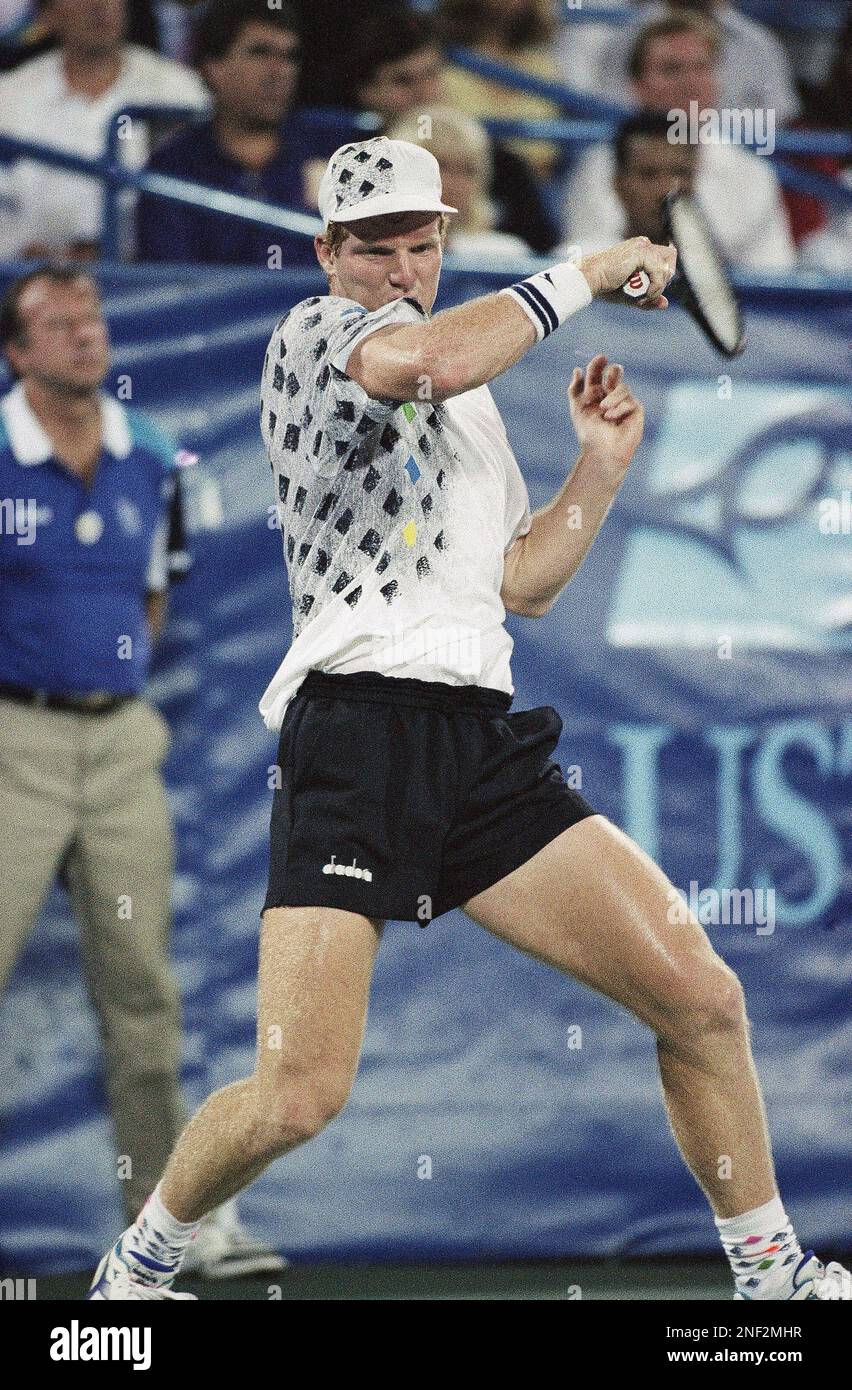 Jim Courier of Dade City, Fla., returns the ball to Andre Agassi of Las ...