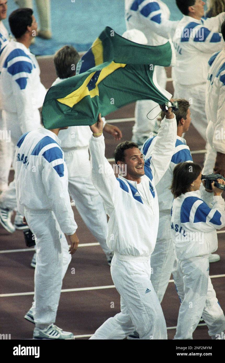 Members of the Brazil team wave, as they parade in the Olympic Stadium ...