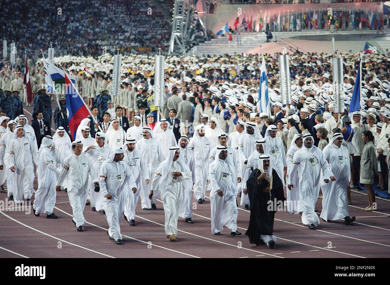 Members of Kuwait's Olympic team walk in Olympic Stadium in Barcelona ...