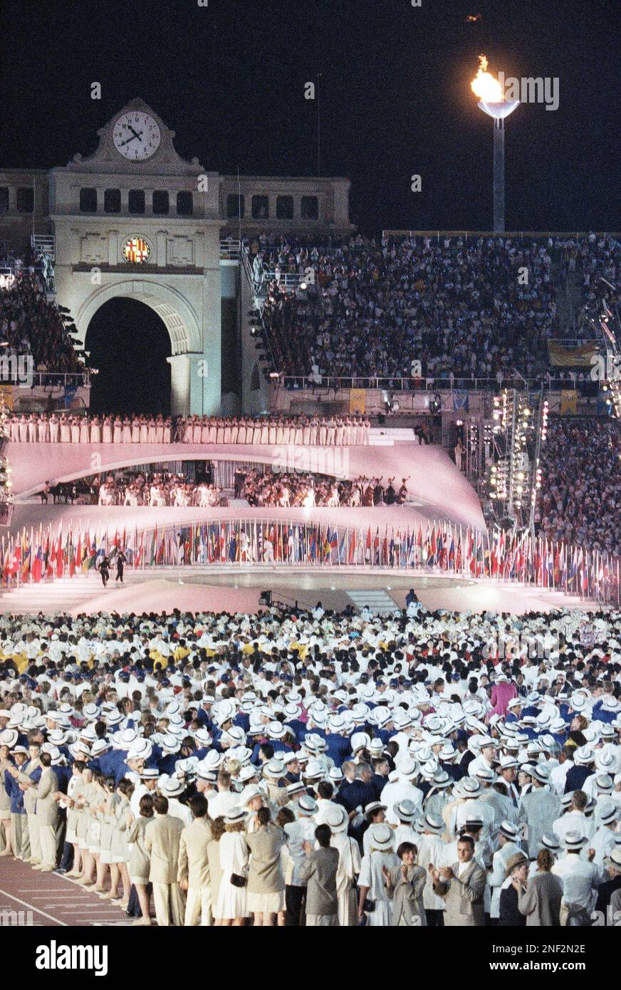 The Olympic Torch burns high above the Olympic Stadium in Barcelona ...