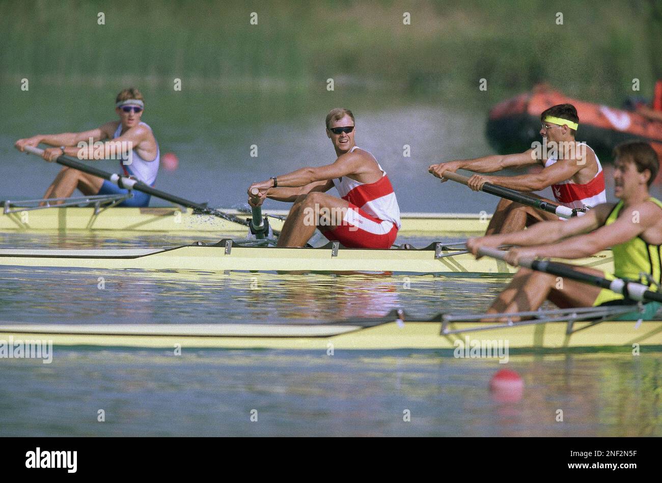 Canada's Henry Hering, center, concentrates on his rowing, as teammate ...
