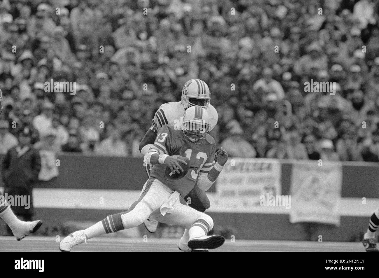 Miami Dolphins quarterback Dan Marino (13) goes down as New England ...