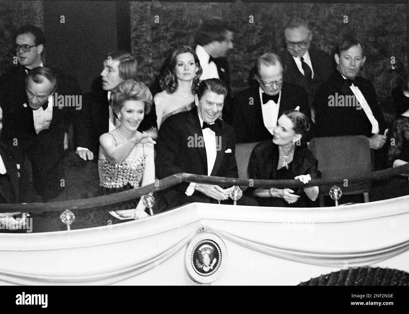 President Ronald Reagan and first lady Nancy Reagan smile as they enter ...