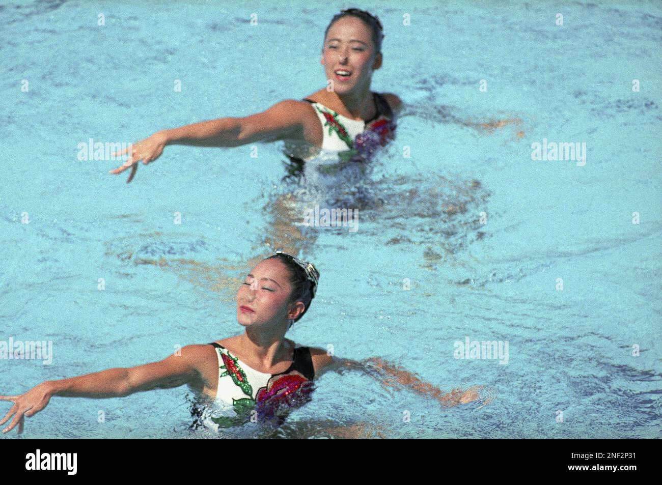 Japan's Fumiko Okuno, bottom, and Aki Takayama compete in the synchronized swimming duet ...