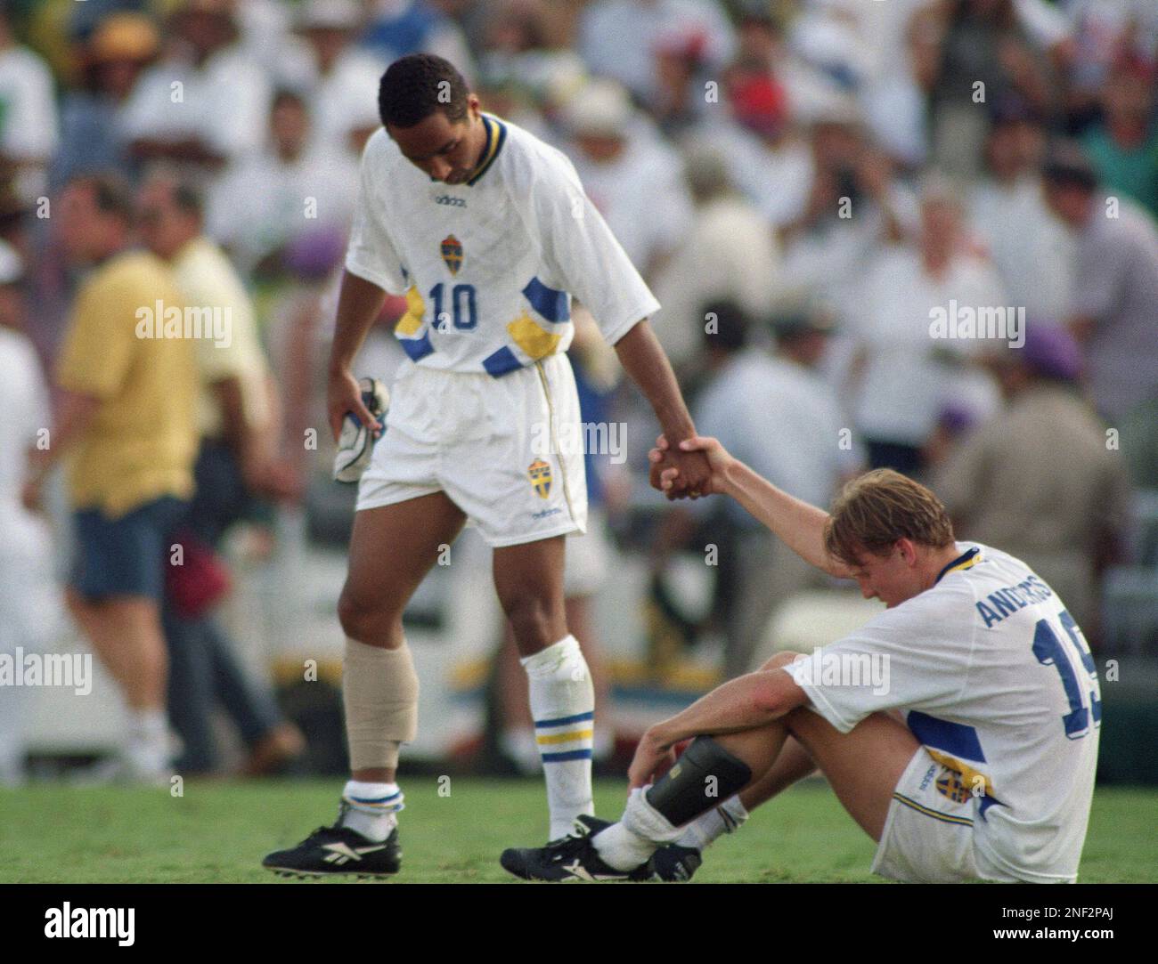 Kennet Andersson (19) is consoled by Swedish teammate Martin Dahlin (10 ...