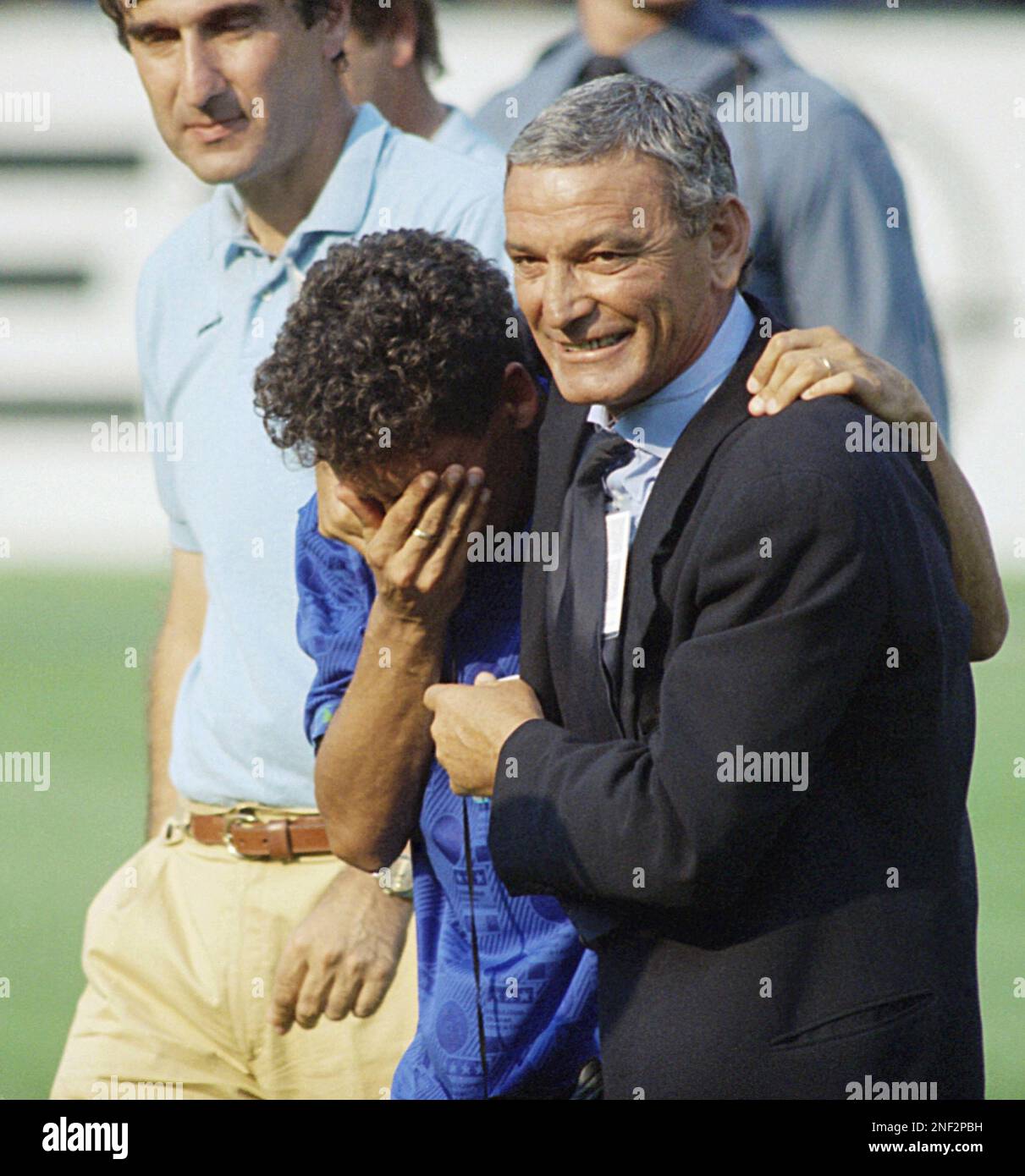 Italian soccer star Robert Baggio, left, weeps on the shoulder of ...