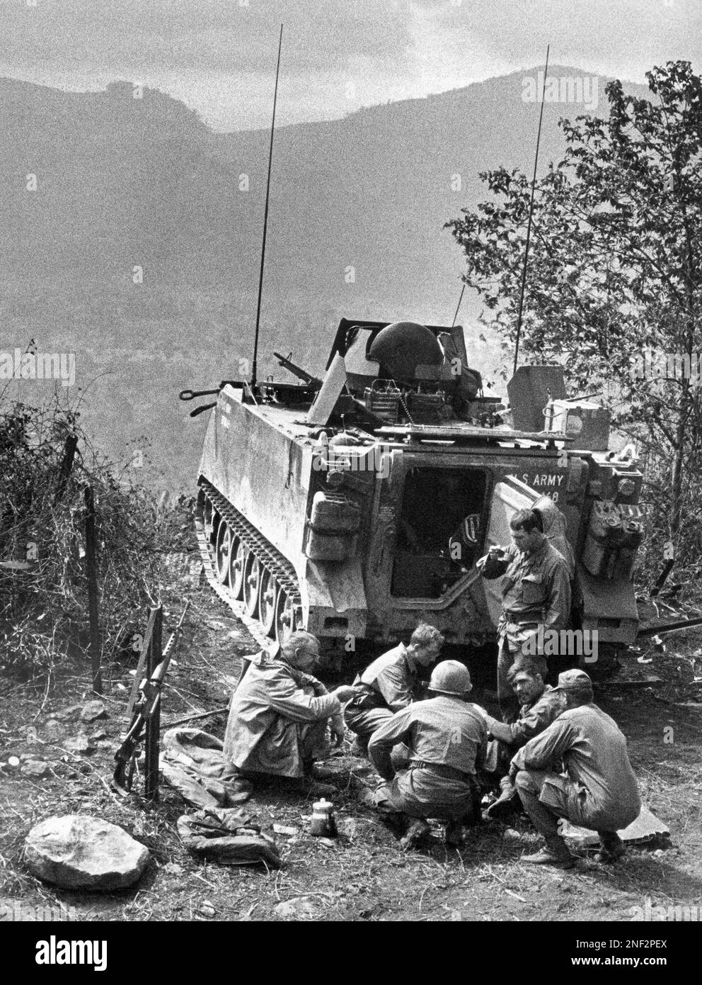 A group of American GI's, members of the Americal Division, take a chow ...