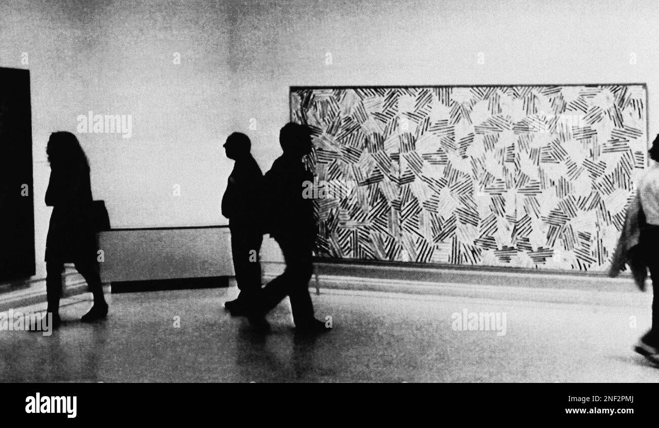 Visitors look at paintings by American artist Jasper Johns at the American Pavilion of the ...