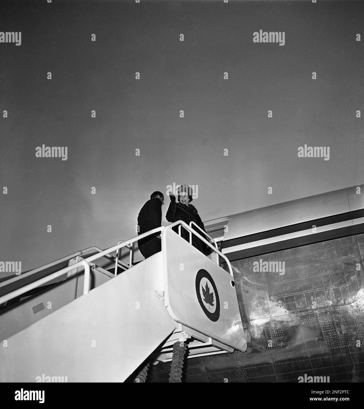 Queen Elizabeth II waves from the ramp of a plane as she and Prince ...