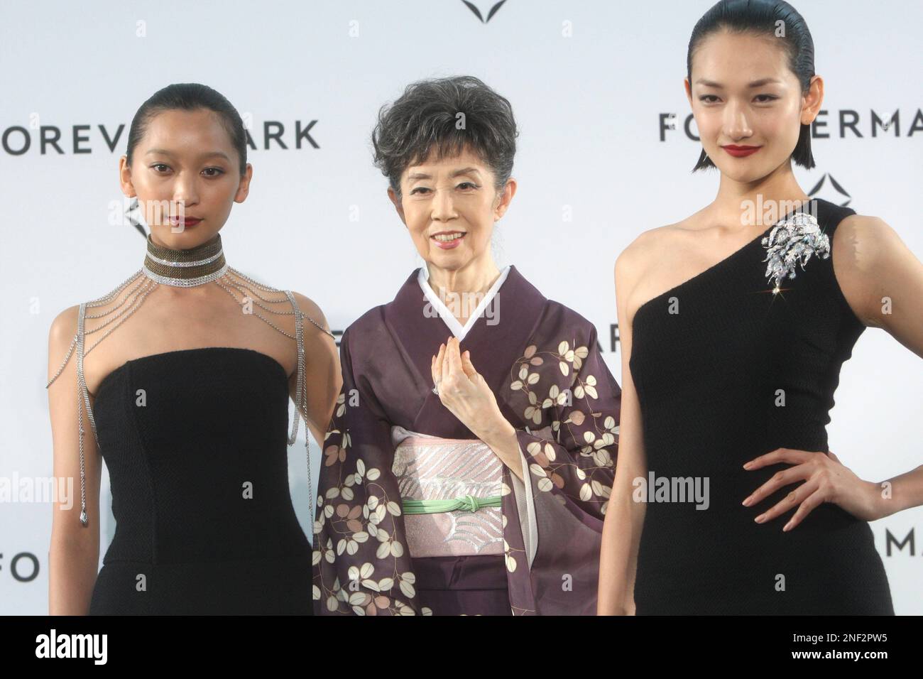 Japanese actress Mitsuko Mori, center, is accompanied by Japanese ...