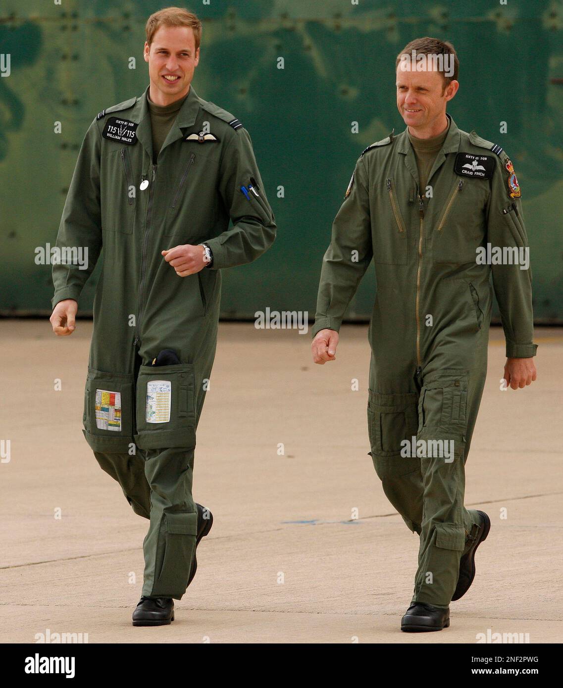 Britain's Prince William, left, with instructor Craig Finch, right ...