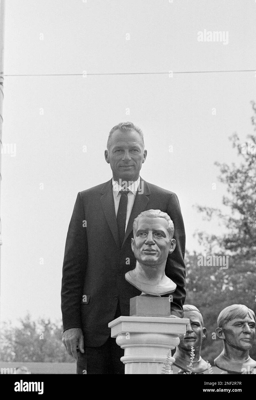 Green Bay Packers Don Hutson poses with a bust of himself, after he was ...