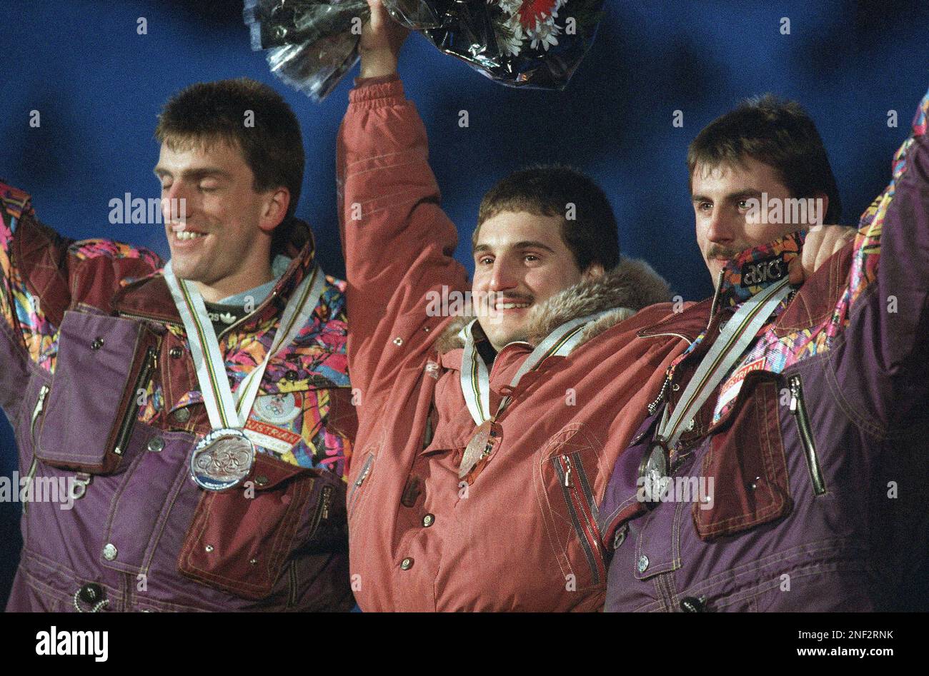 George Hackl of Germany, center, acknowledges cheers from his ...