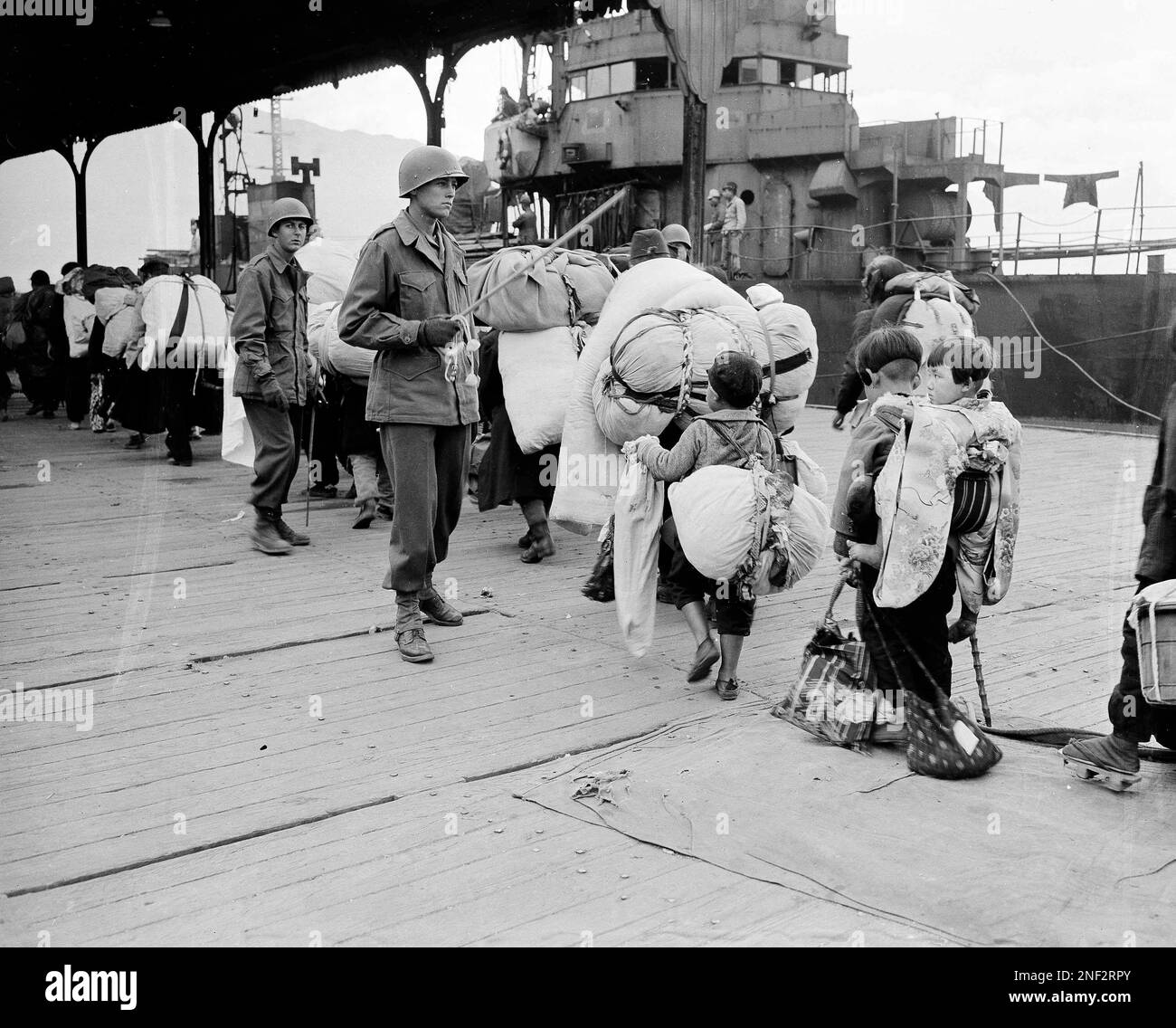 A Japanese child laden with bundles and carrying her tiny brother on ...