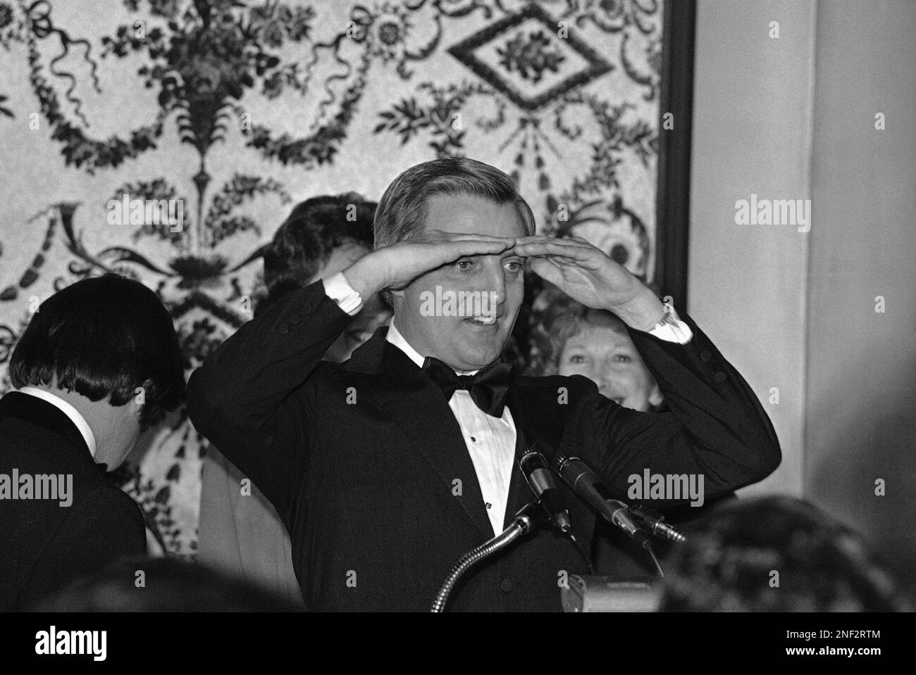 Vice President Walter Mondale shades his eyes from intense television ...