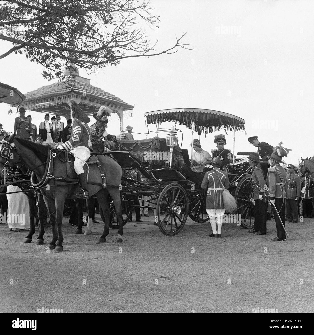 Queen Elizabeth II of Britain and King Mahendra of Nepal drive in an ...