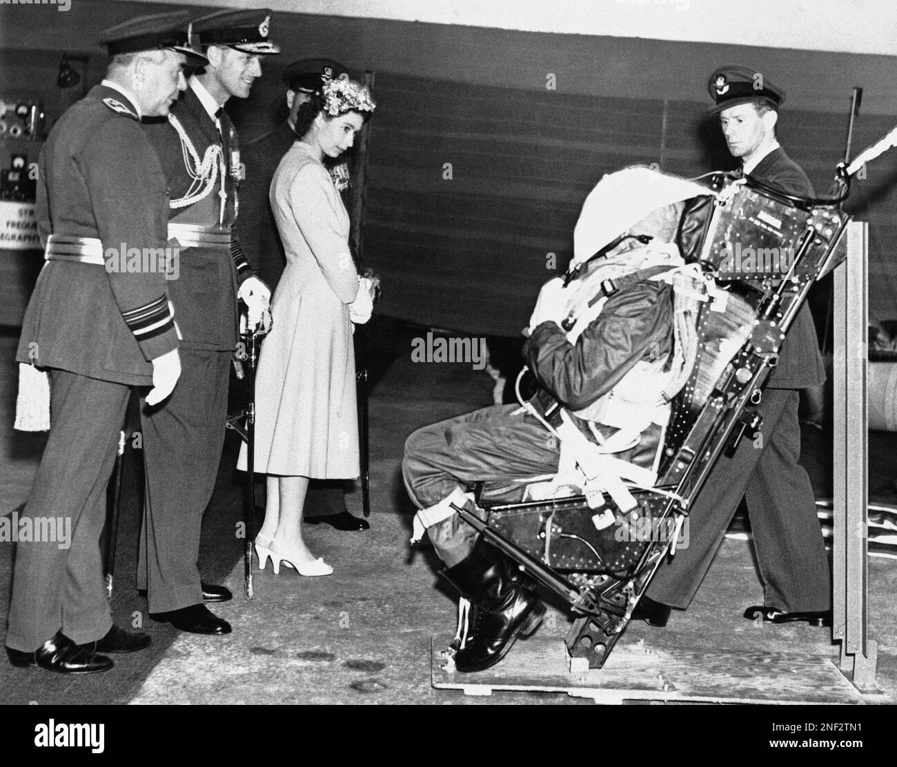 Queen Elizabeth II, accompanied by the Duke of Edinburgh, second from ...