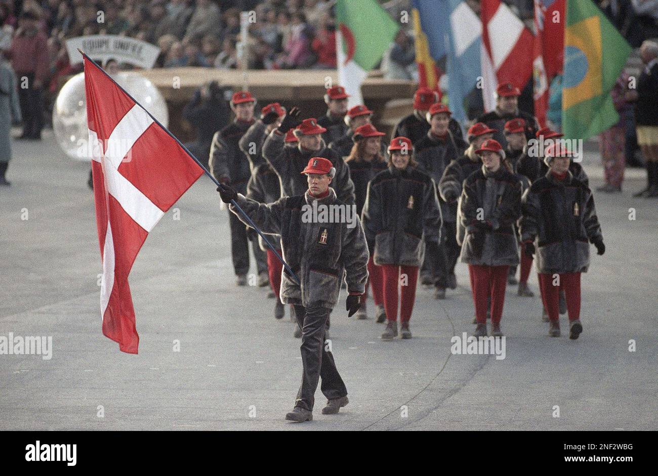 Ebbe Hartz carries the Danish flag as she leads her teammates through ...