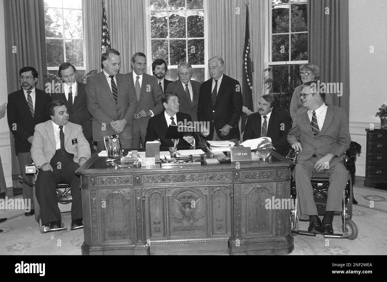 U.S. President Ronald Reagan is flanked by members of the Senate and ...