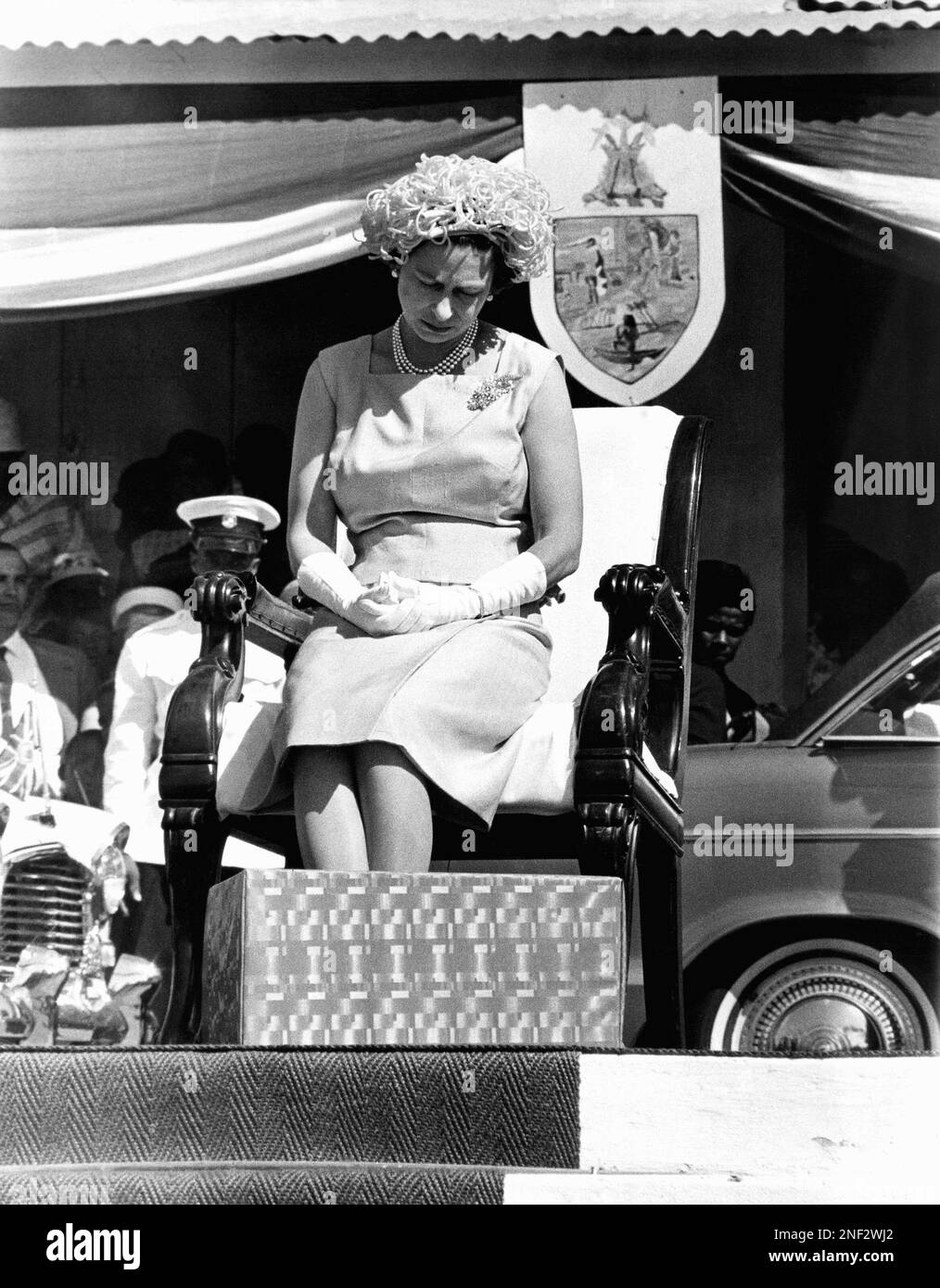 Queen Elizabeth II looks tired as she sits on the throne in Warner Park ...